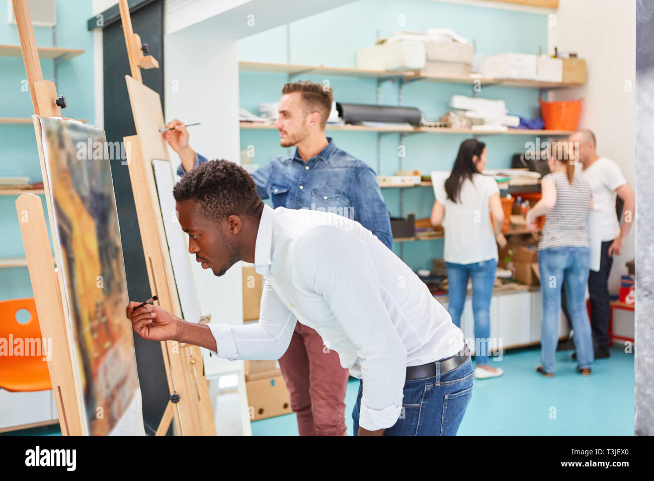 Young students drawing on canvas hi-res stock photography and images ...
