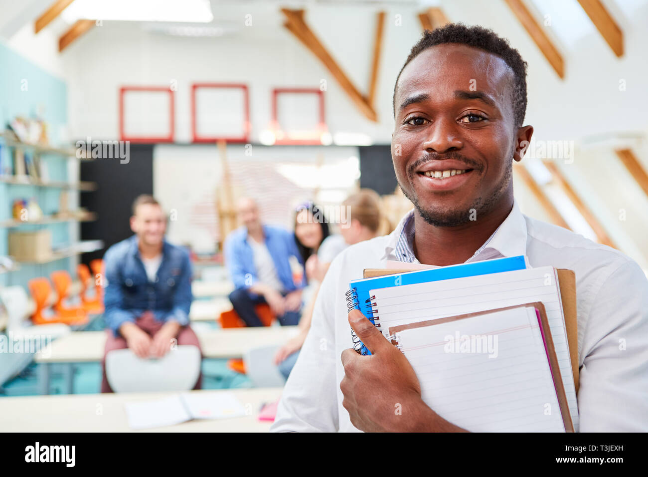 Happy african student with documentation in a seminar of the university ...