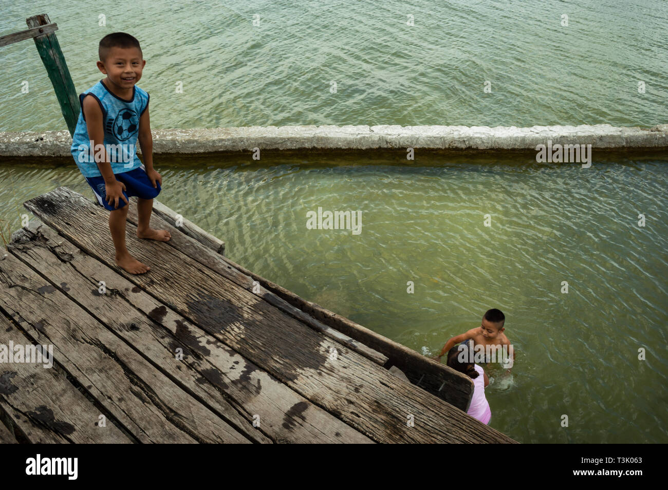 Mayan Children play in the waters of the ancient lake of Chichancanab ...