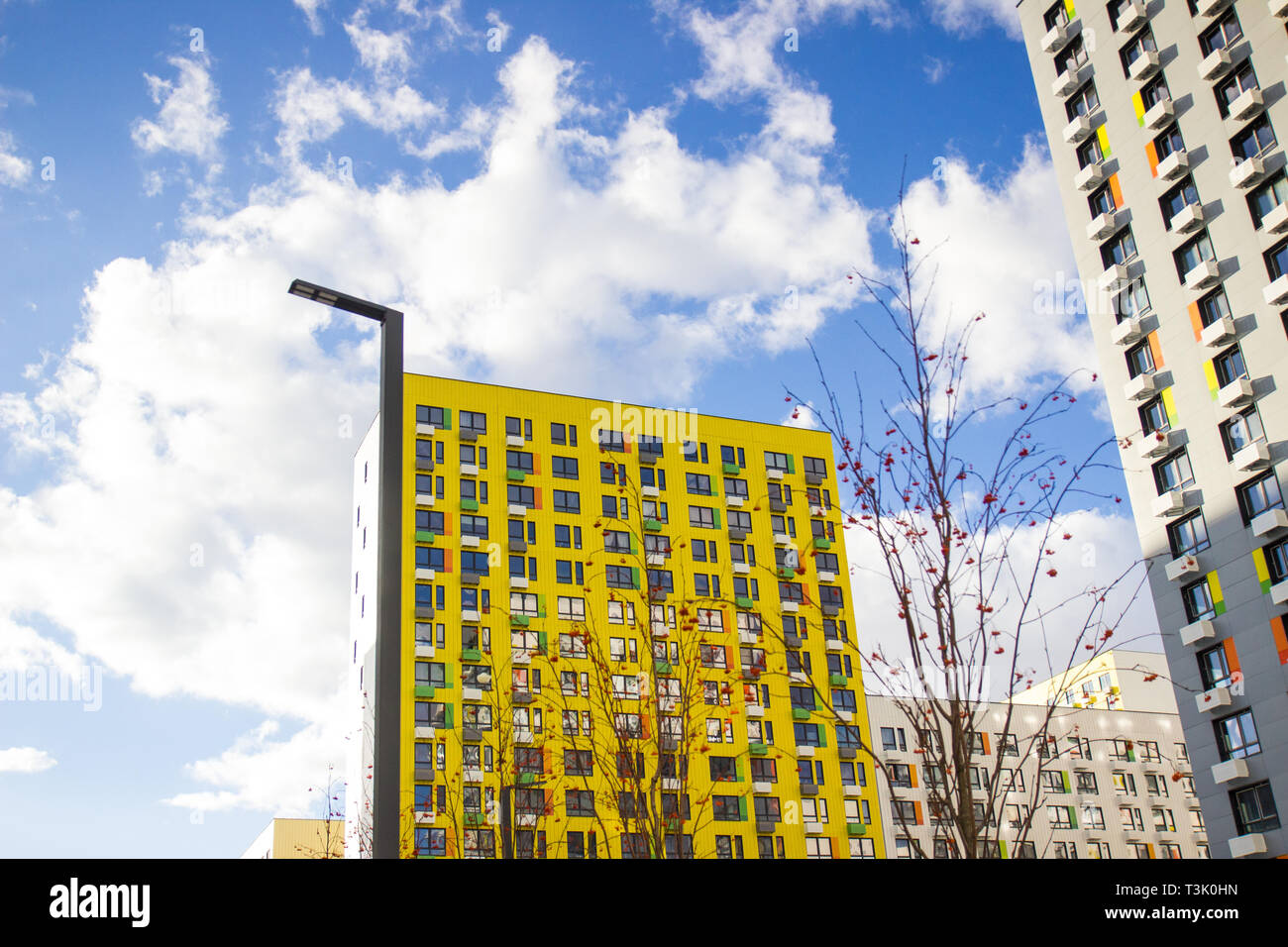 New modern yellow building at blue sky background Stock Photo - Alamy