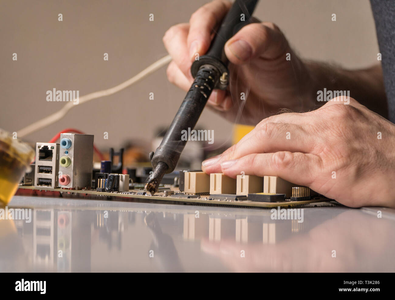technician electronic soldering and repairing computer chip Stock Photo ...