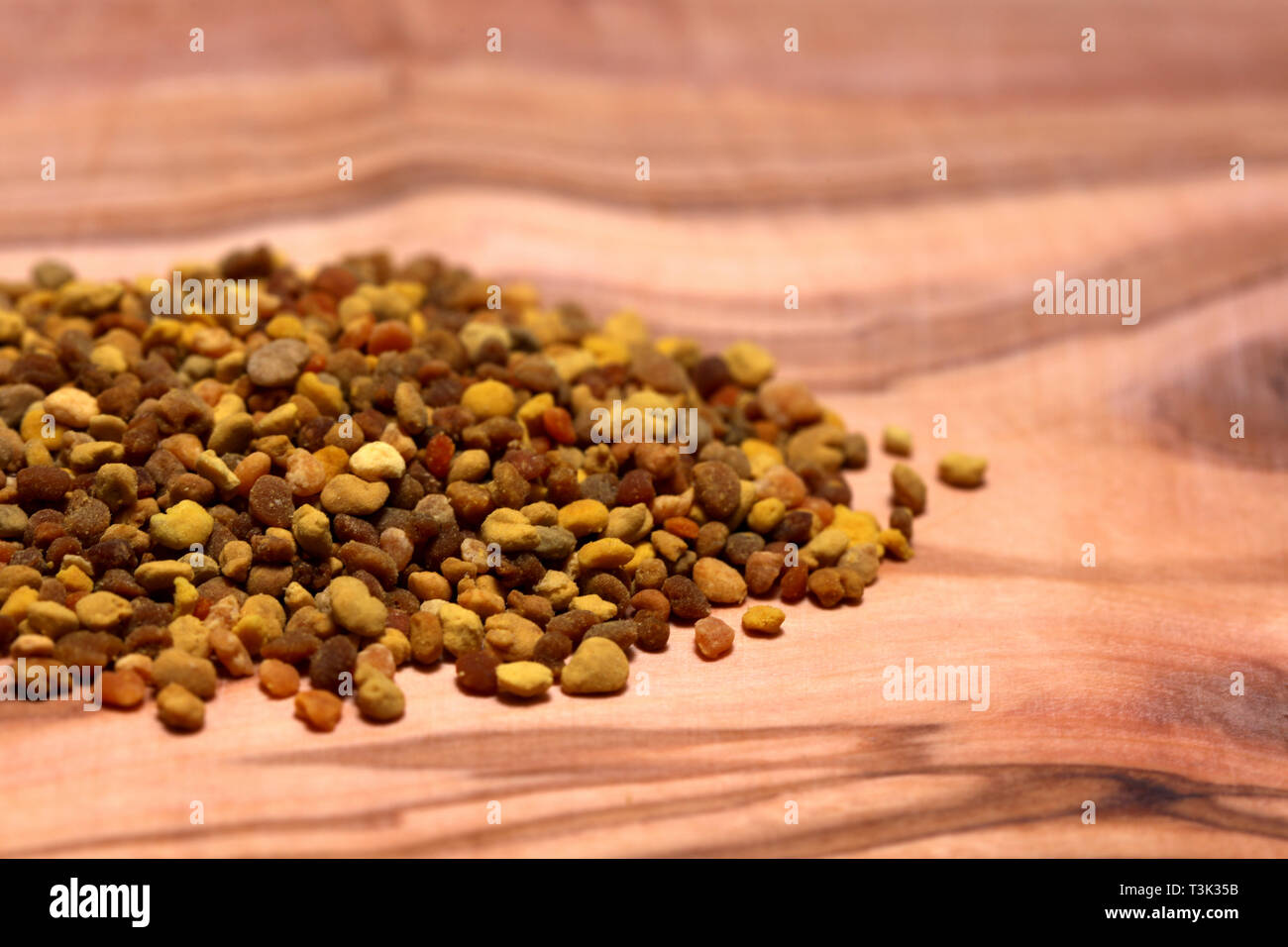 Propolis Flower pollen on wood background Stock Photo - Alamy