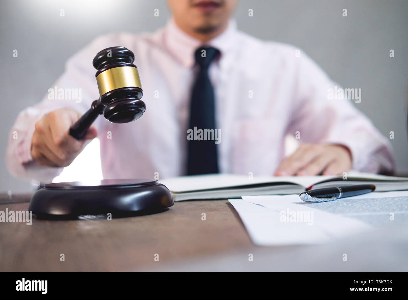 lawyer judge reading documents at desk in courtroom working on wooden ...
