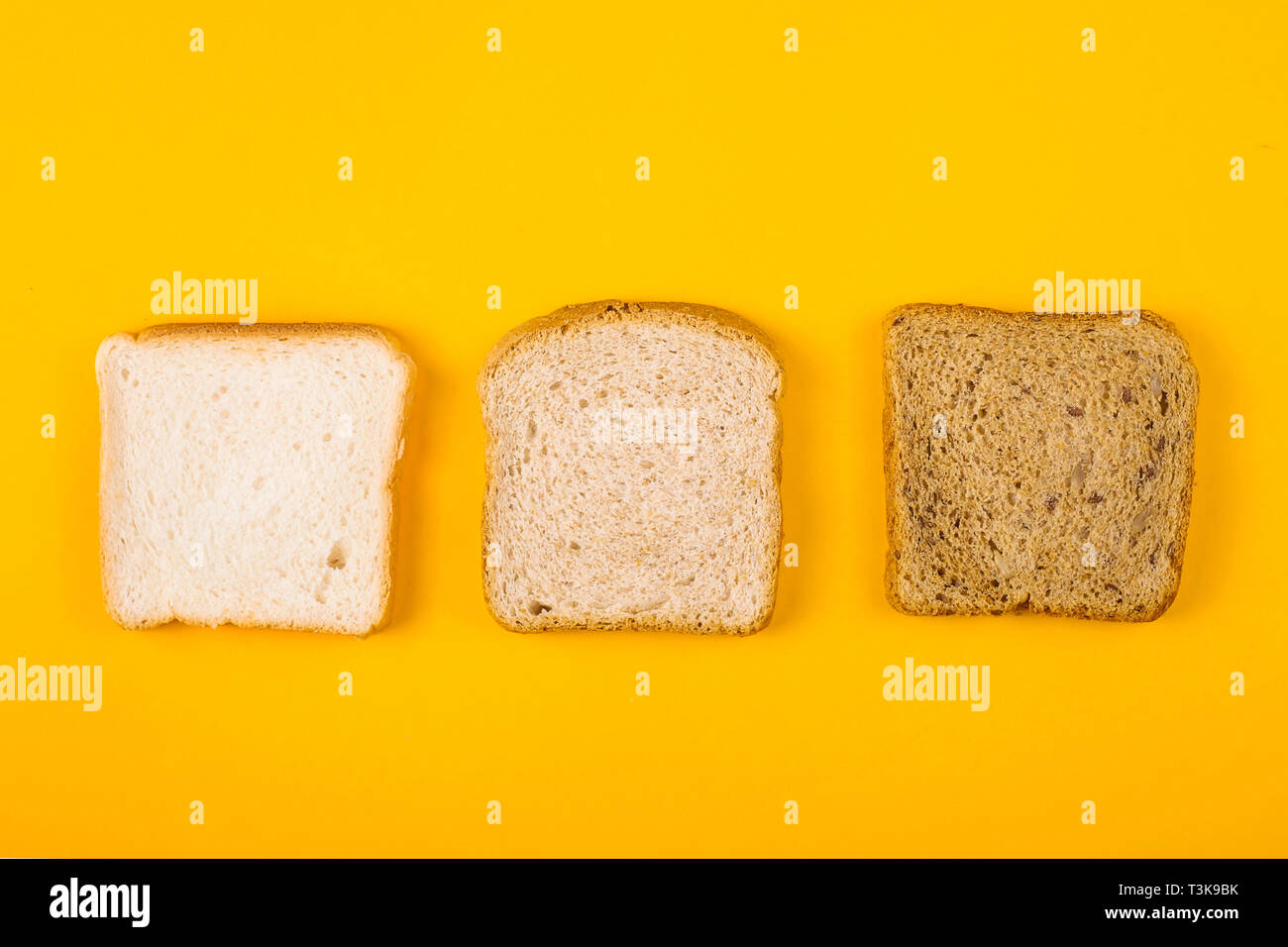 Three different types of toast bread - white, grain and brown on a ...