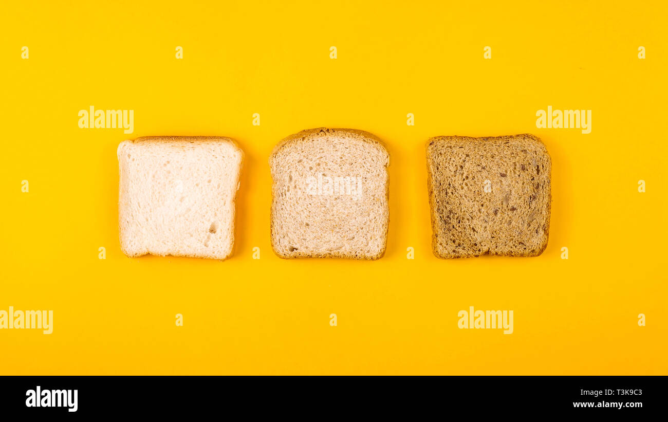 Three different types of toast bread - white, grain and brown on a ...