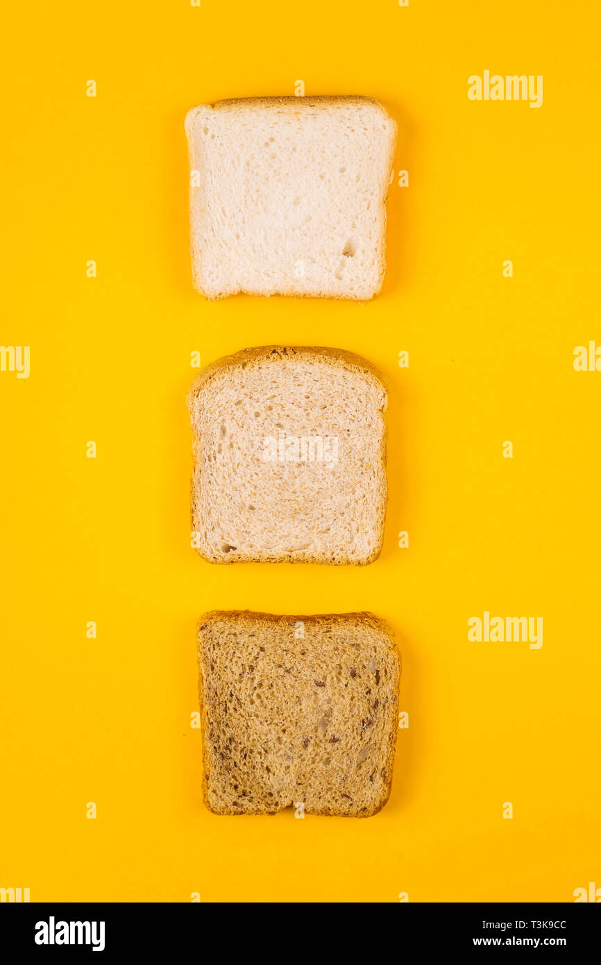 Three different types of toast bread - white, grain and brown on a ...
