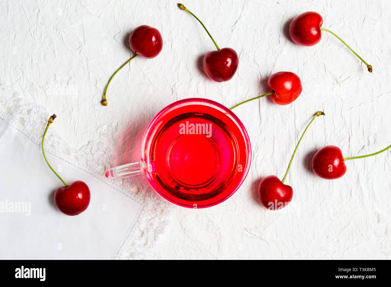 Cherry fruit tea in a glass with fresh fruits Stock Photo - Alamy