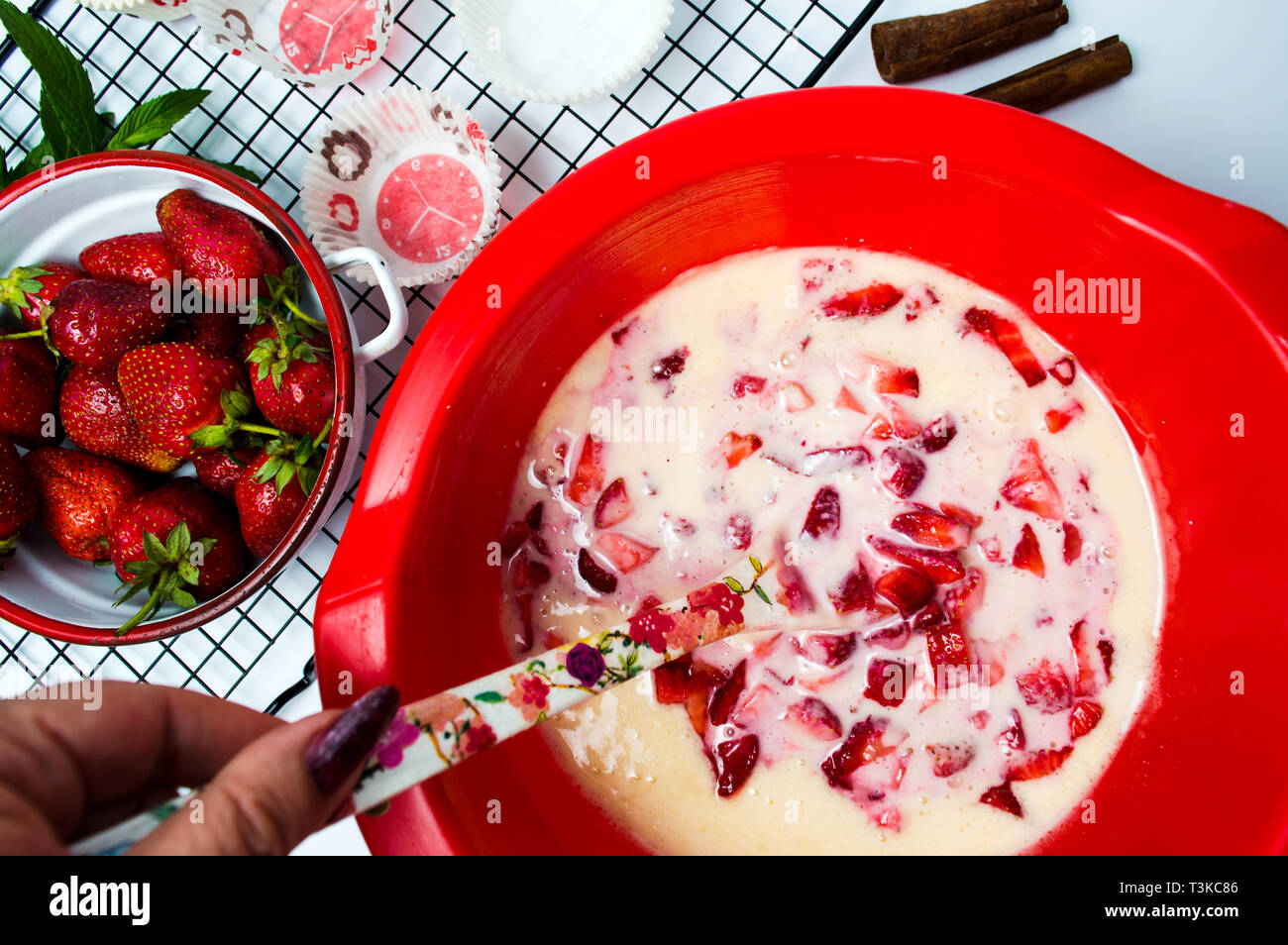 Woman making strawberries cream for a cake first person Stock Photo - Alamy
