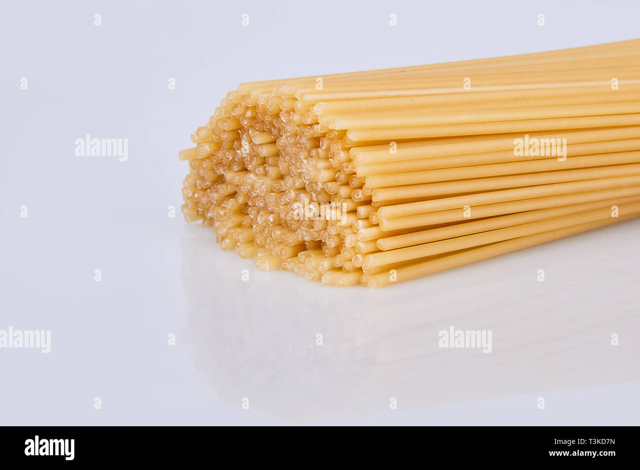 Spaghetti isolated on white background. Yellow sheaf raw long pasta ...