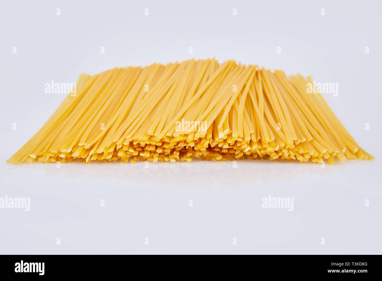 Spaghetti isolated on white background. Yellow sheaf raw long pasta ...
