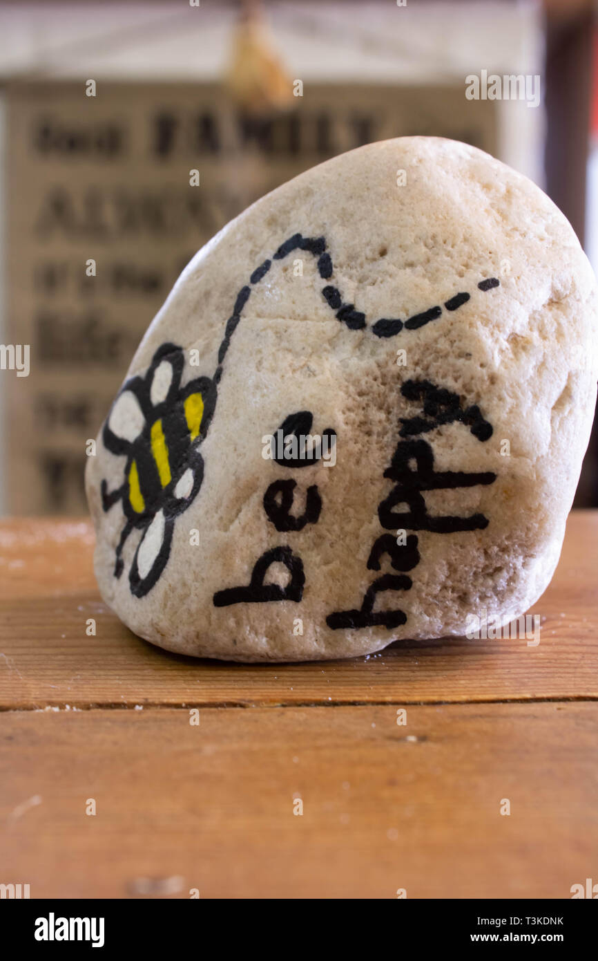 Painted Bee happy stone Stock Photo - Alamy
