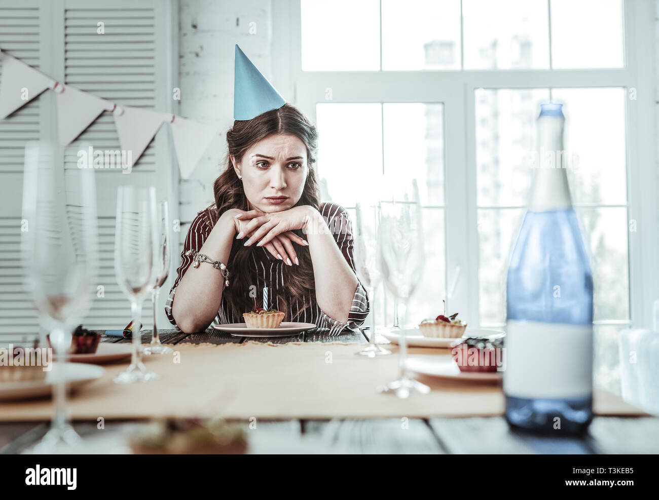 Young woman celebrating her birthday without friends Stock Photo - Alamy