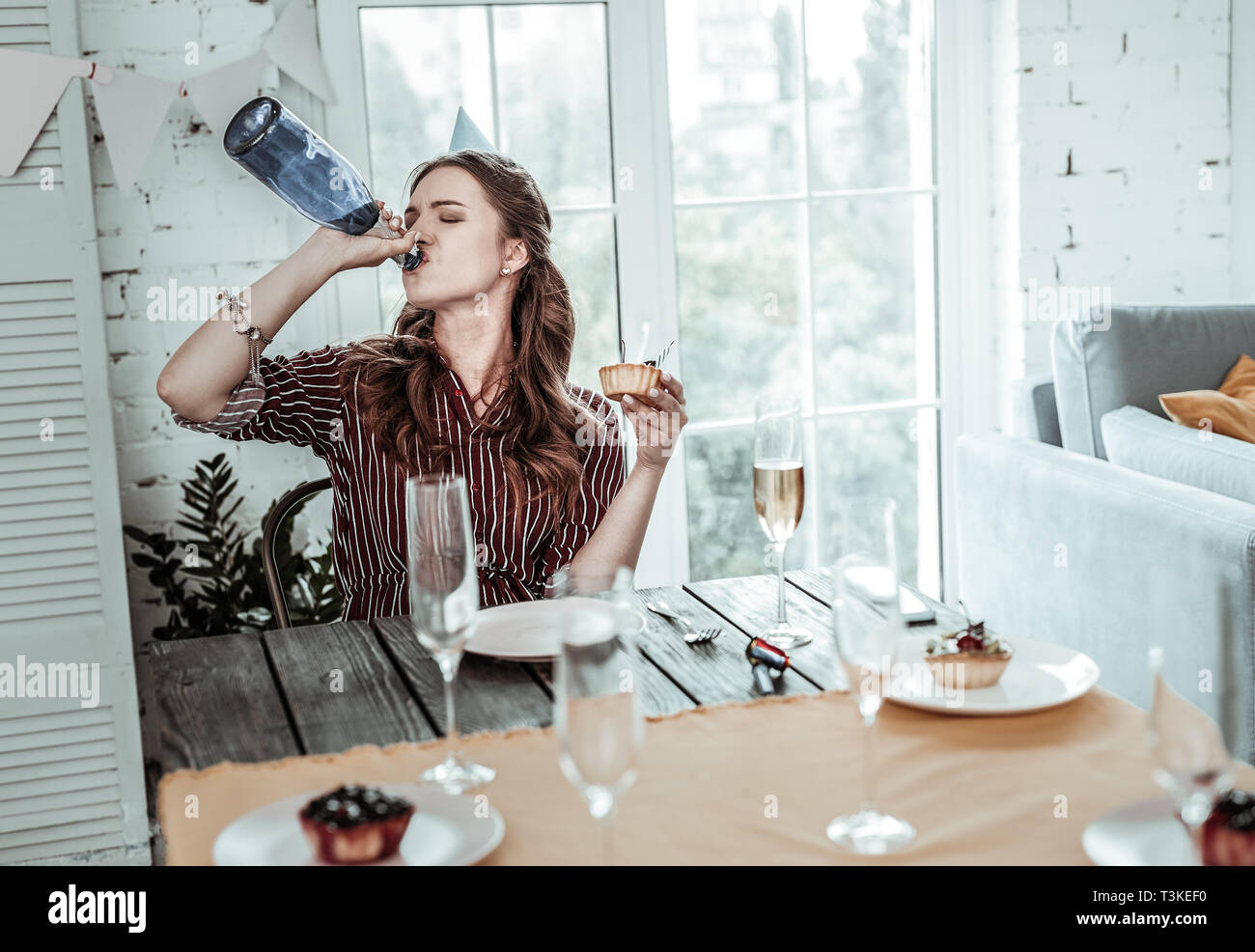 Woman drinking from champagne bottle hi-res stock photography and ...