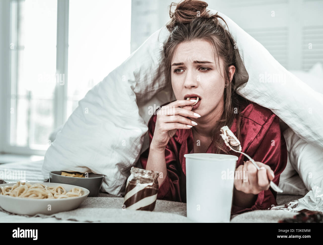 Depressed woman is overeating because of stress Stock Photo - Alamy