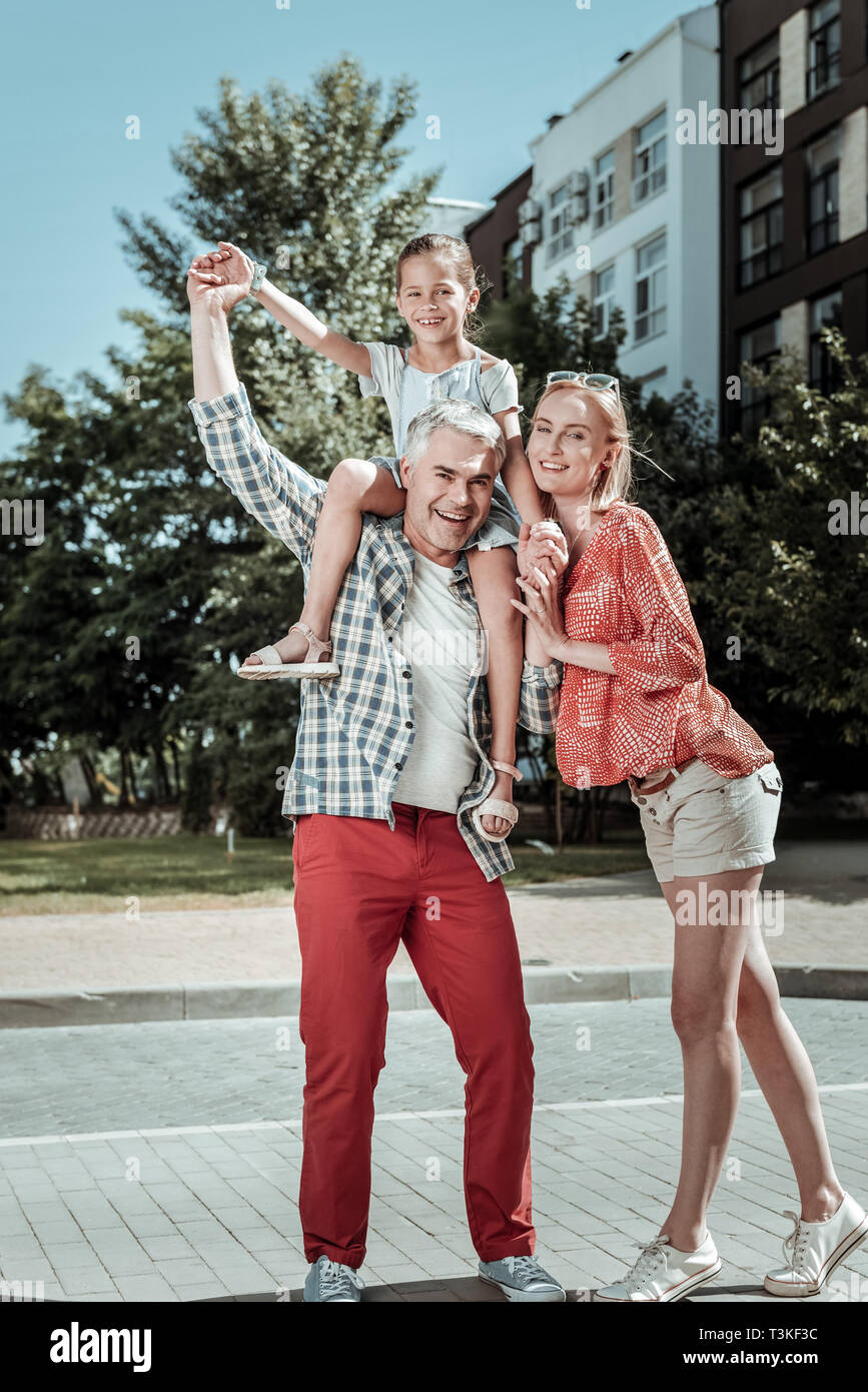 Good looking united family enjoying their day together Stock Photo - Alamy