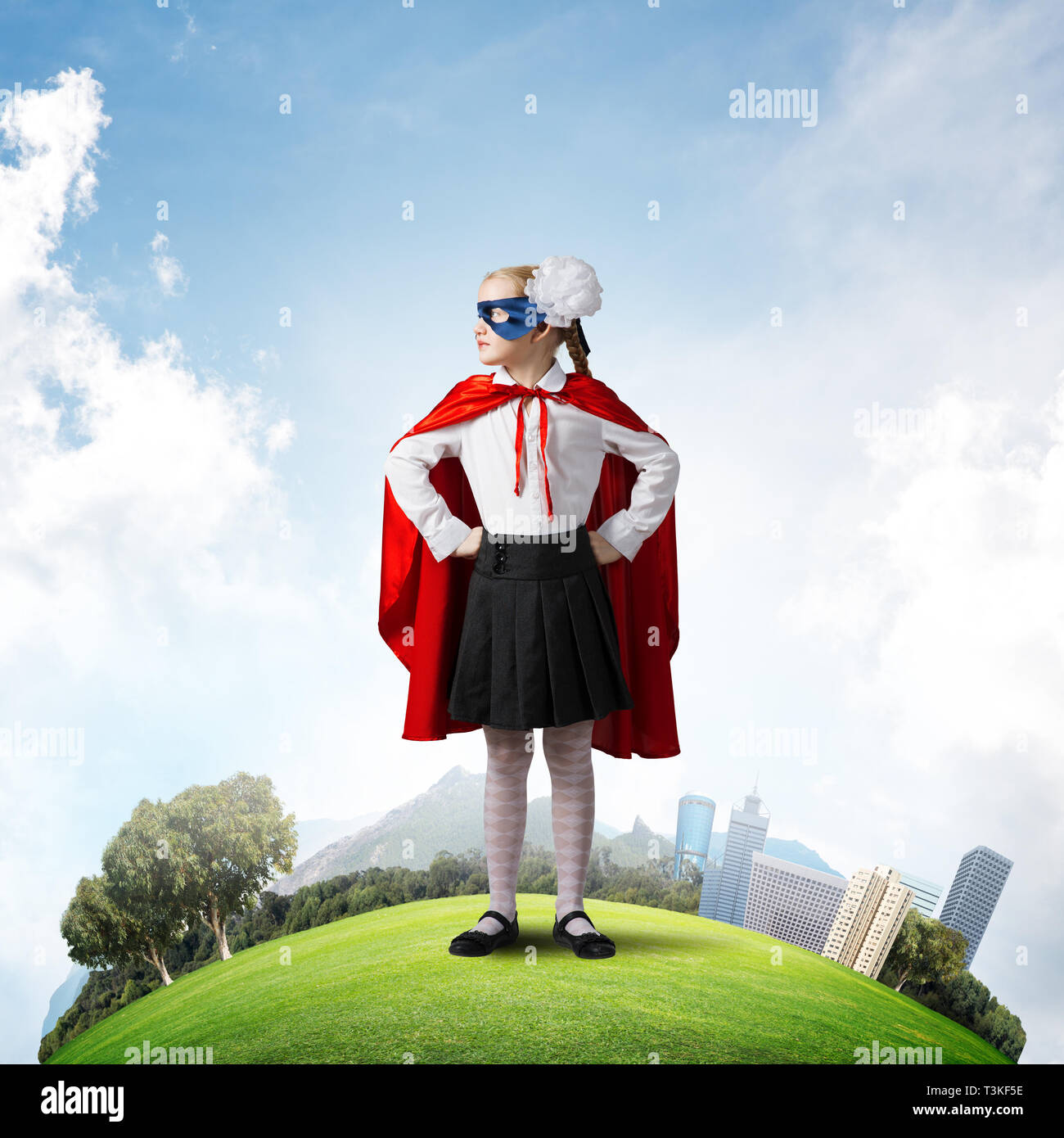 Girl power concept with cute kid guardian against cityscape background ...