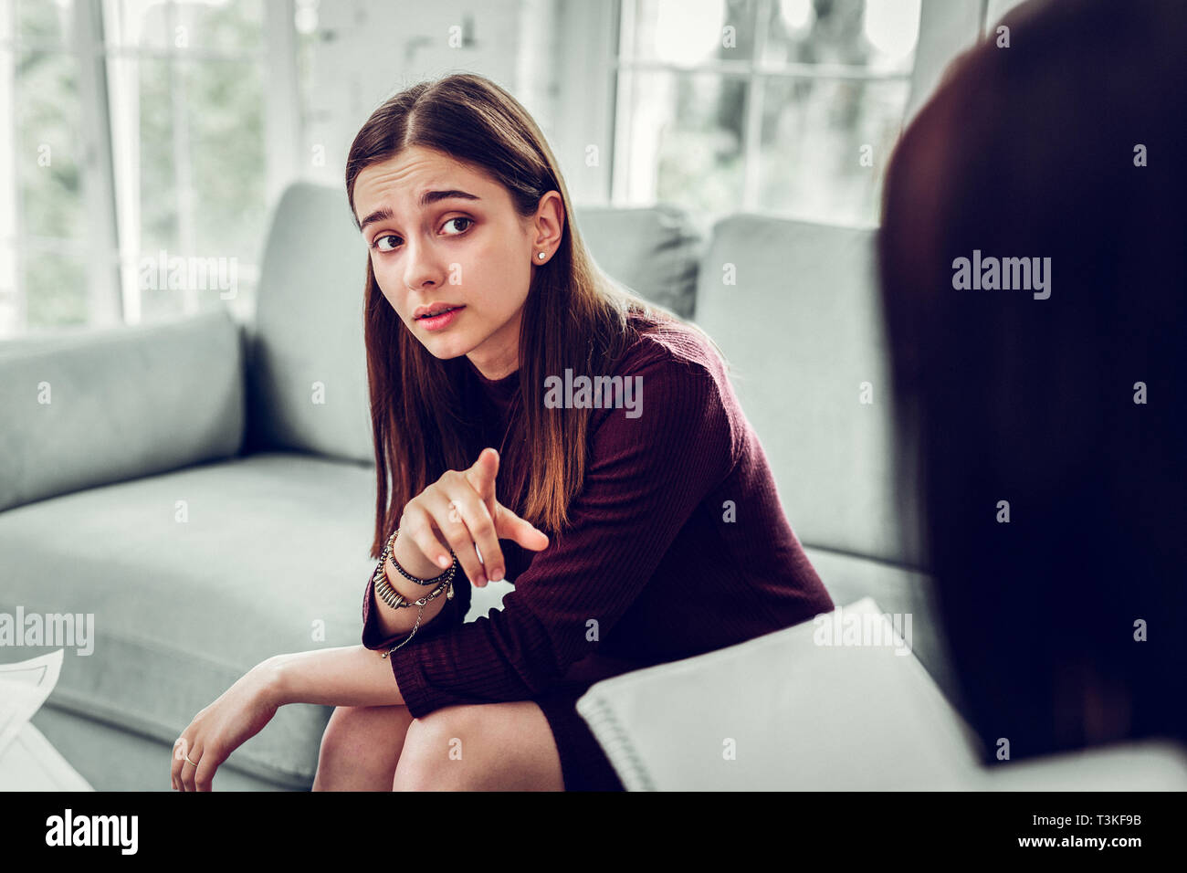 Dark-eyed woman asking some questions to her psychologist Stock Photo ...
