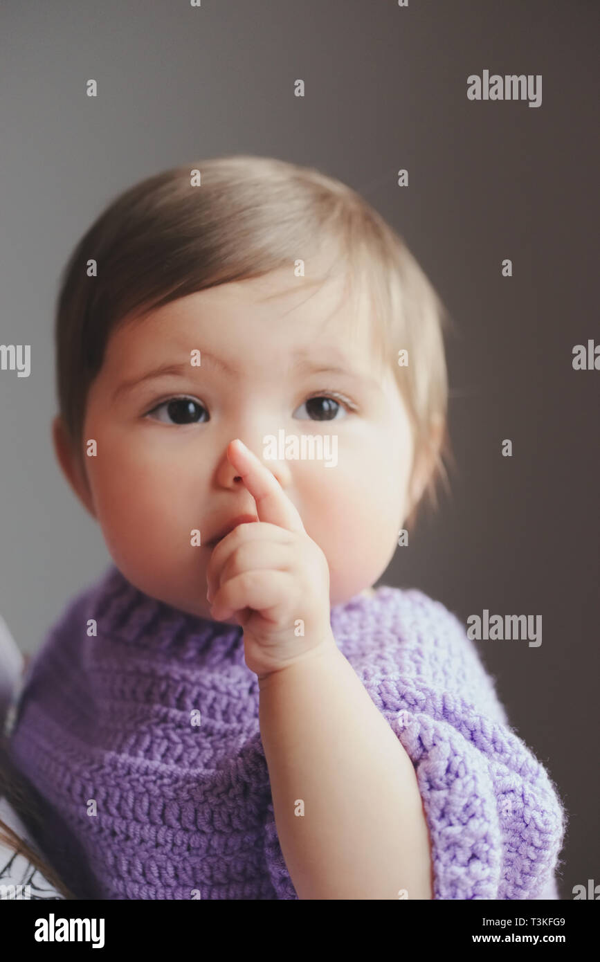 cute happy baby with finger in mouth Stock Photo - Alamy