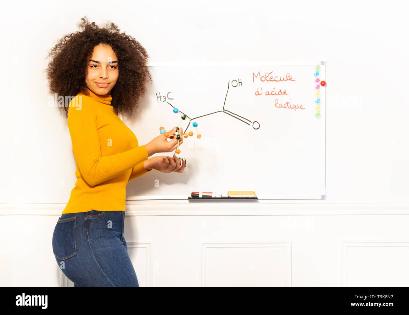 Young woman in chemistry class draw acid molecule Stock Photo - Alamy