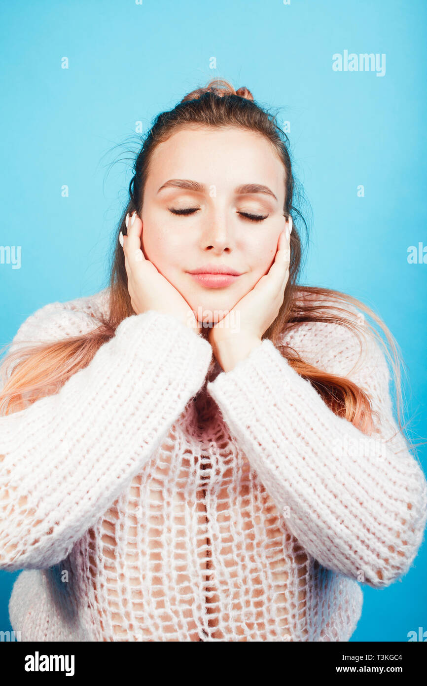 young pretty teenage modern hipster girl posing emotional happy on blue ...