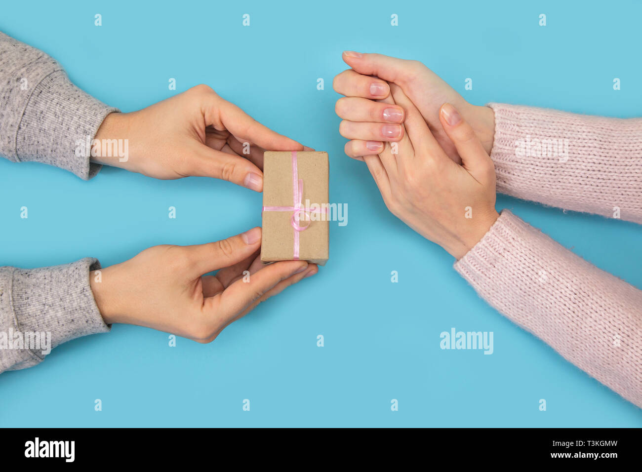 Women's hand goes to the man's hand on blue background. Men's hands ...