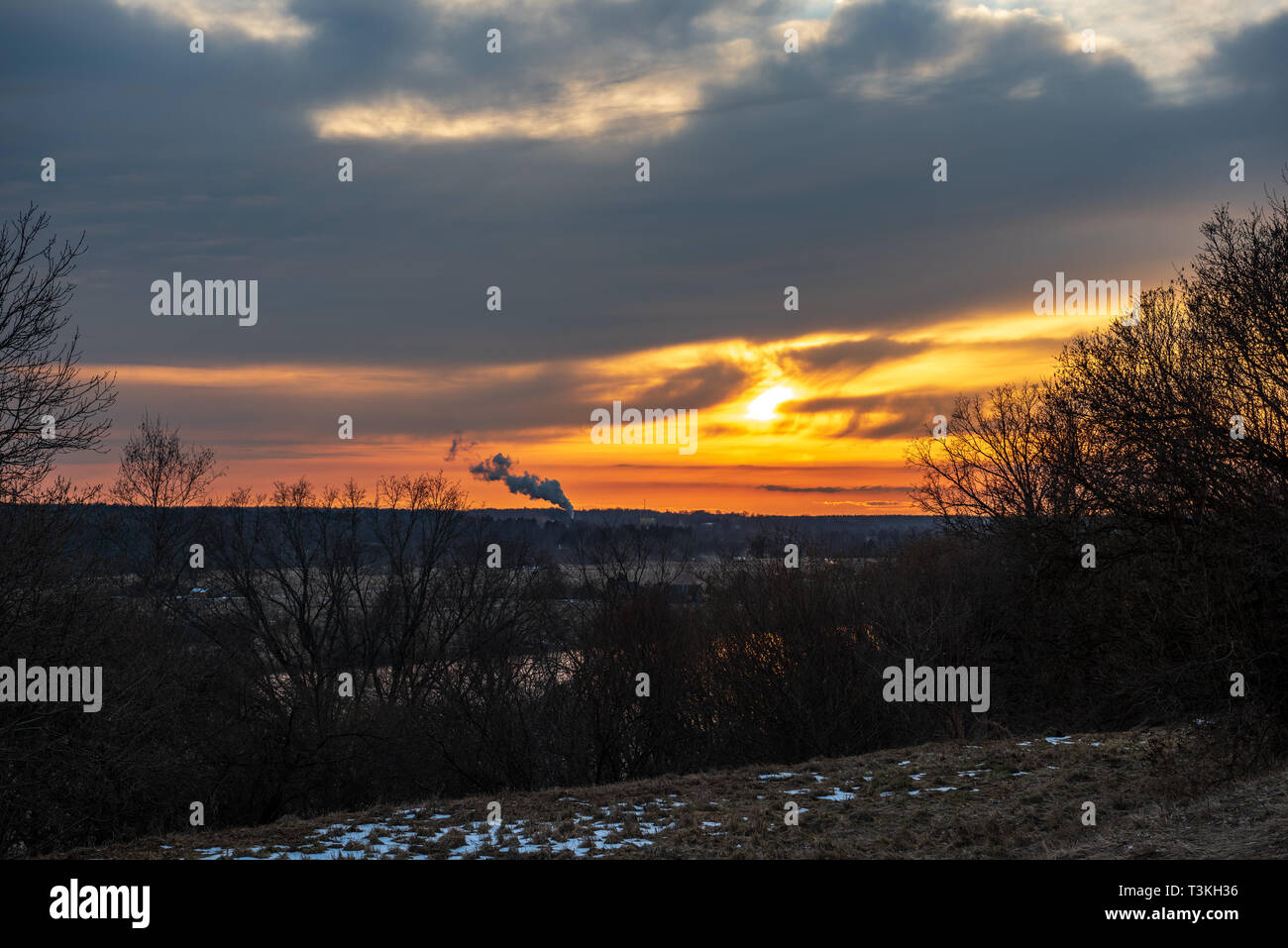 orange red sunset in winter in woods with calm water in river Stock ...