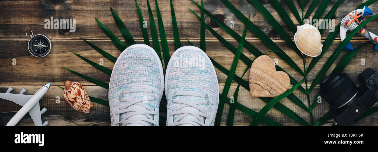 Top view of travel accessories on wood plank floor for tropical beach ...