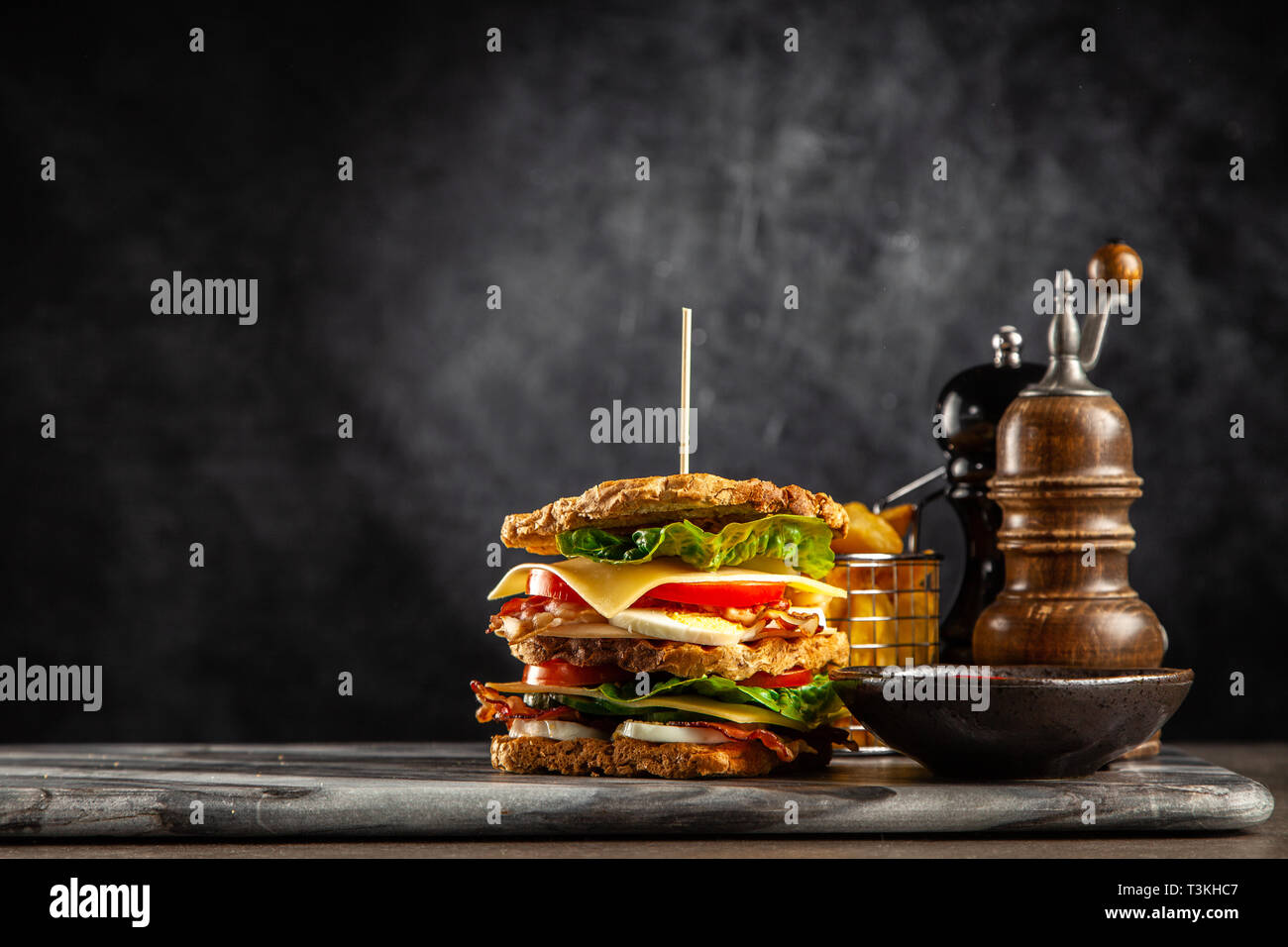 Tall club sandwich with eggs, turkey and bacon Stock Photo - Alamy