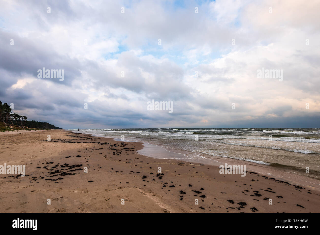 empty sea beach before storm with dramatic clouds and shadows from ...