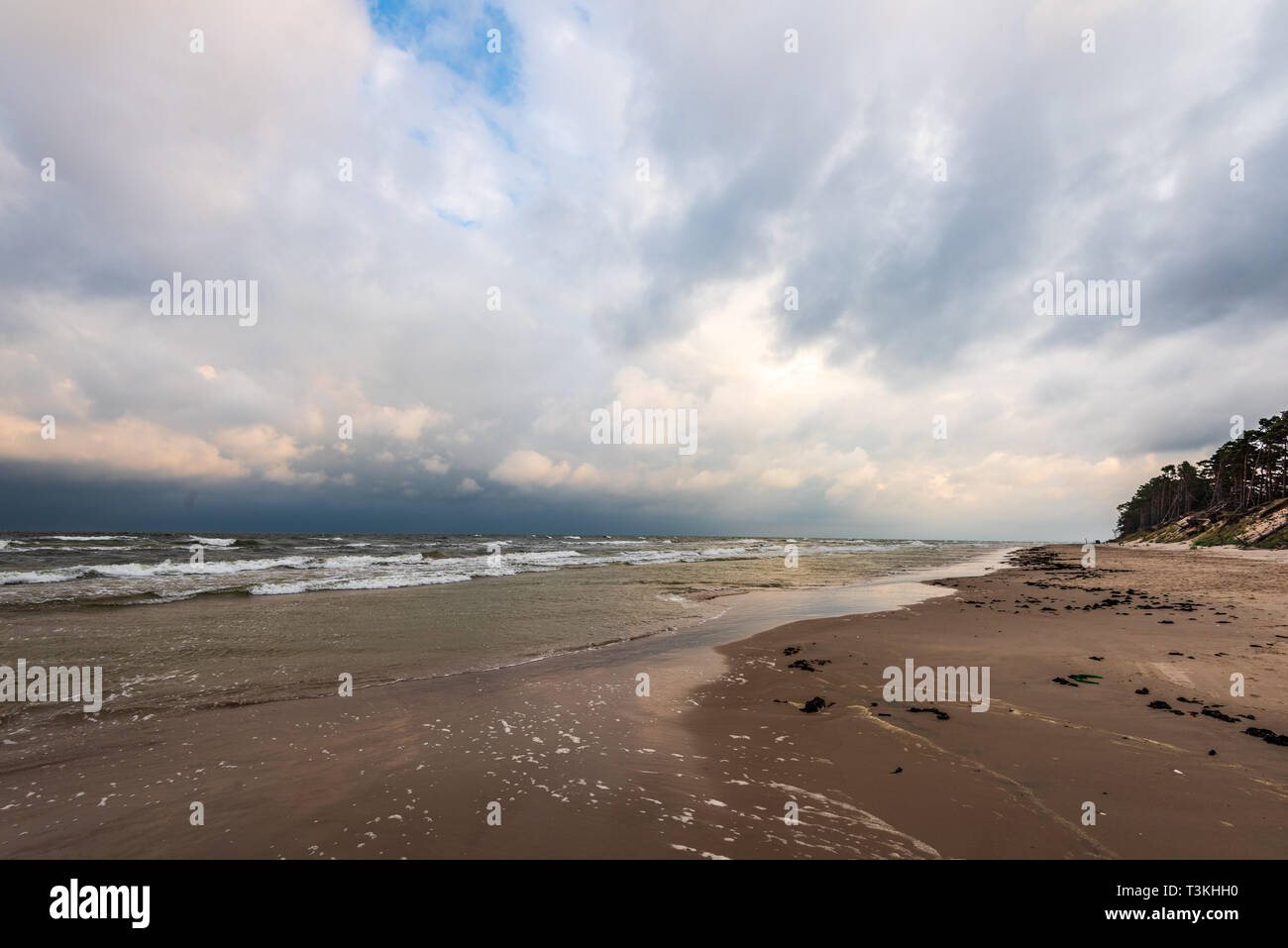 empty sea beach before storm with dramatic clouds and shadows from ...