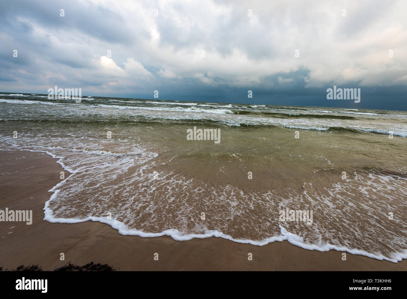 empty sea beach before storm with dramatic clouds and shadows from ...