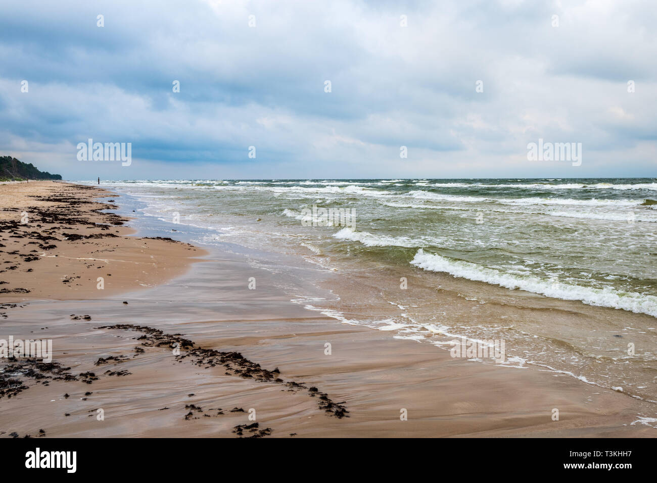 empty sea beach before storm with dramatic clouds and shadows from ...