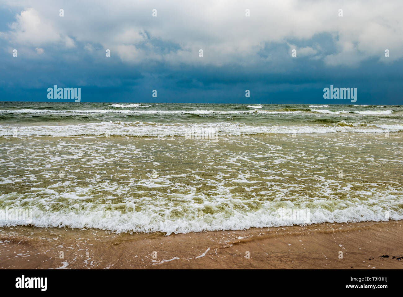 empty sea beach before storm with dramatic clouds and shadows from ...