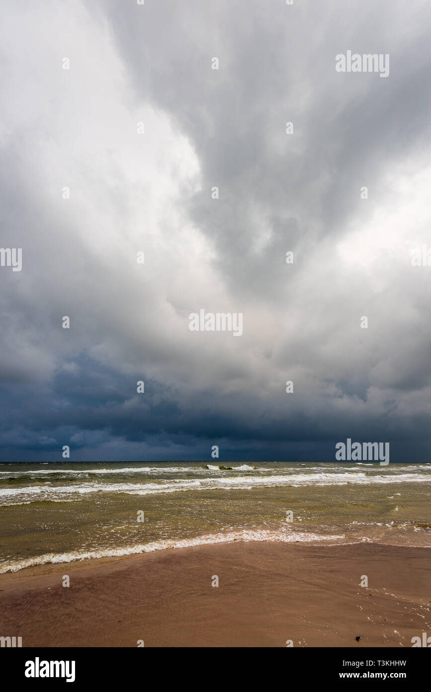 empty sea beach before storm with dramatic clouds and shadows from ...