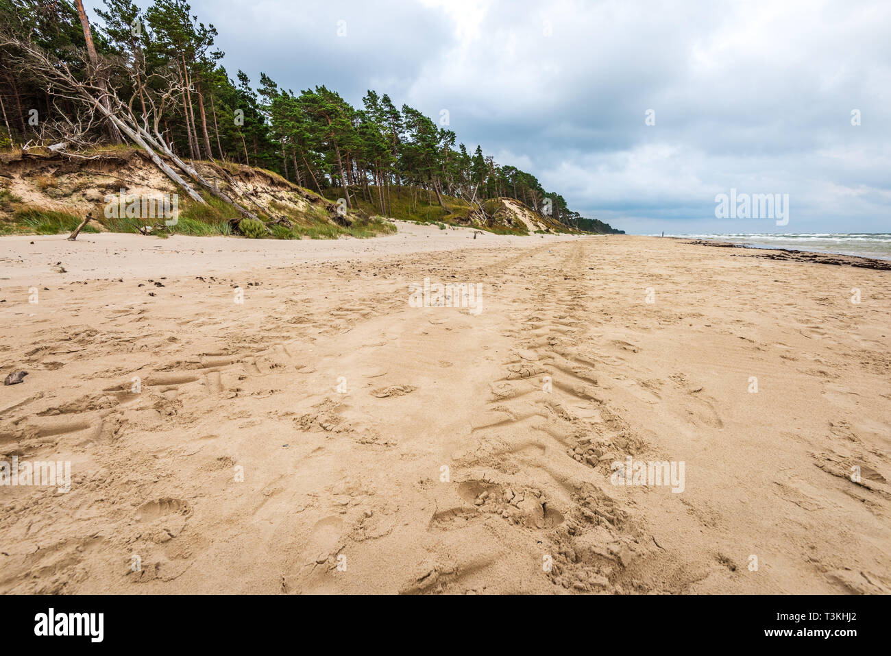 empty sea beach before storm with dramatic clouds and shadows from ...