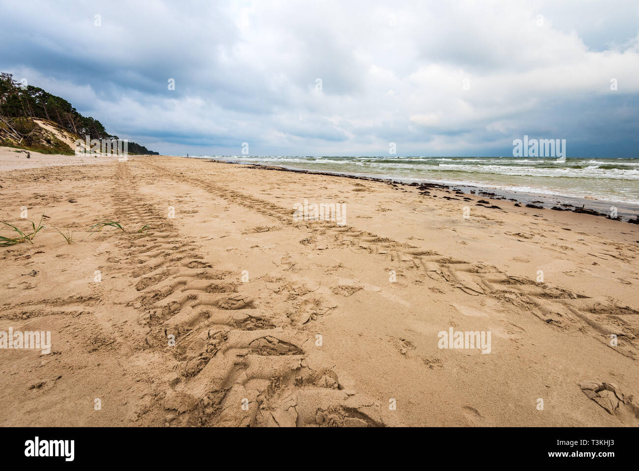 empty sea beach before storm with dramatic clouds and shadows from ...