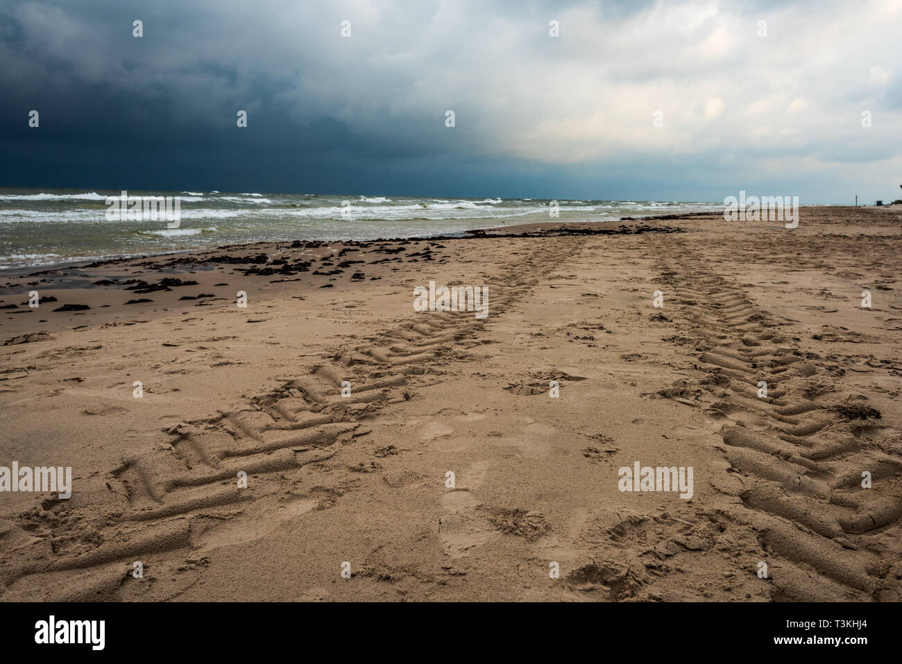 empty sea beach before storm with dramatic clouds and shadows from ...