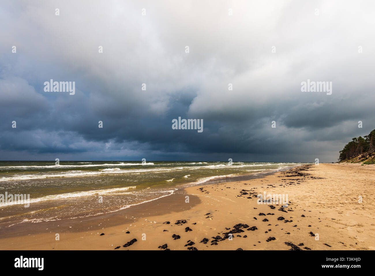 empty sea beach before storm with dramatic clouds and shadows from ...
