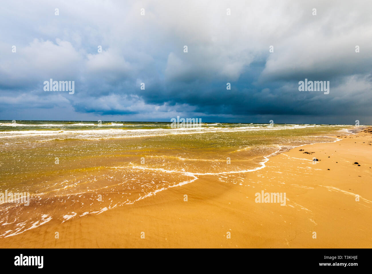 empty sea beach before storm with dramatic clouds and shadows from ...