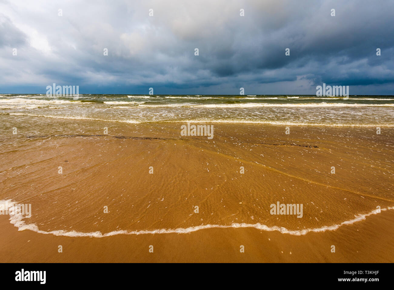 empty sea beach before storm with dramatic clouds and shadows from ...