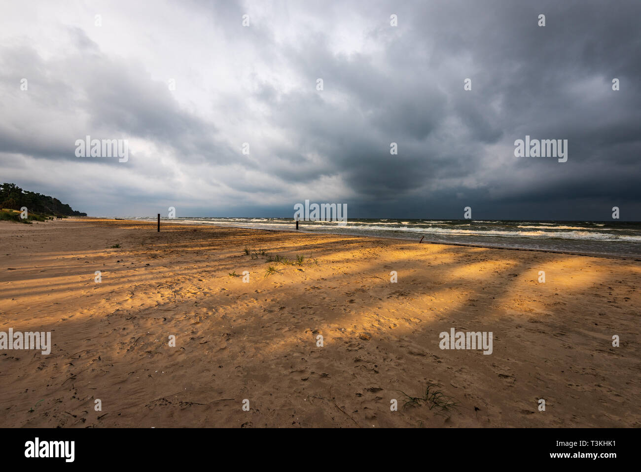 empty sea beach before storm with dramatic clouds and shadows from ...