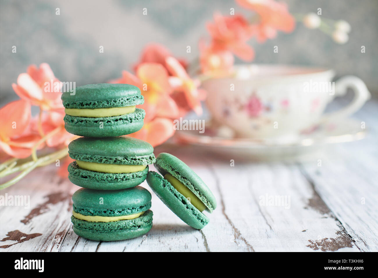 Stack of fresh french green tea macarons on a white rustic table with ...