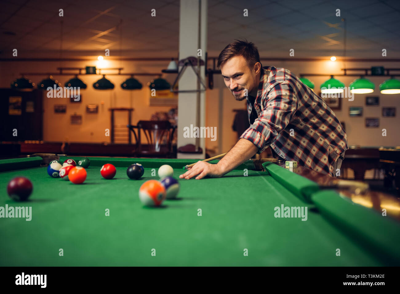 Male billiard player with cue at the table Stock Photo - Alamy