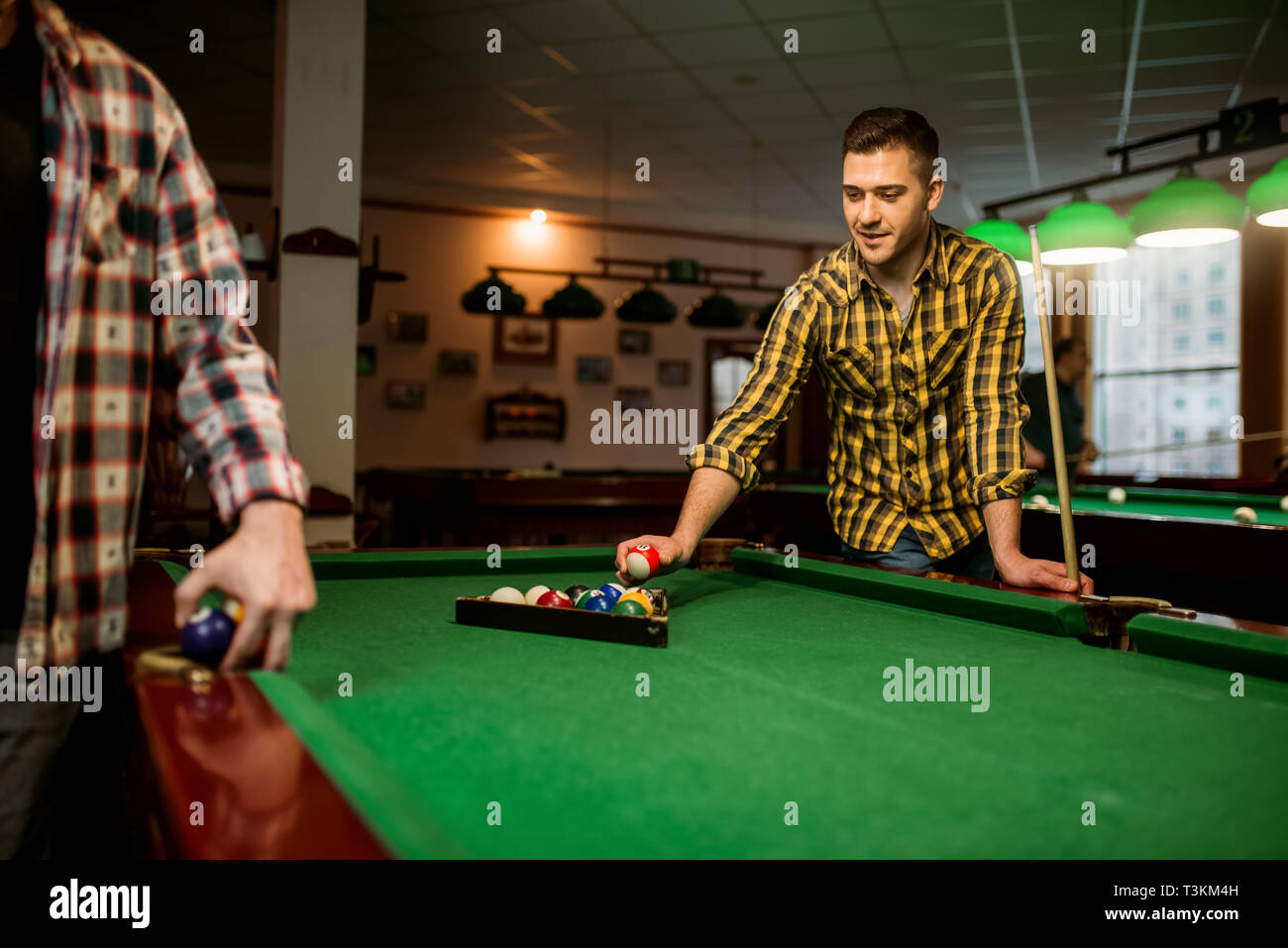 Two male billiard players places colorful balls Stock Photo - Alamy