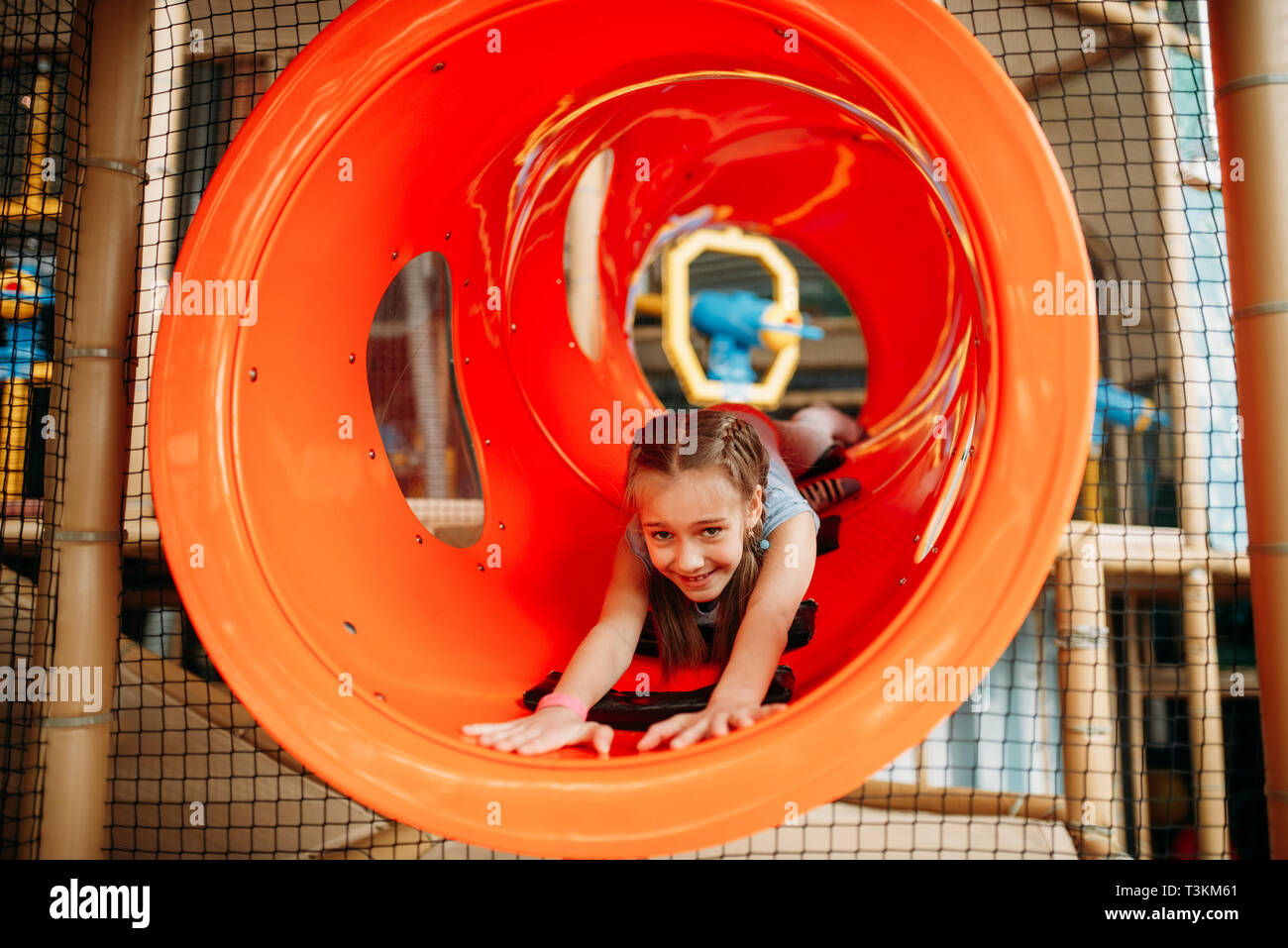 Girl climbing the maze in children game center Stock Photo - Alamy
