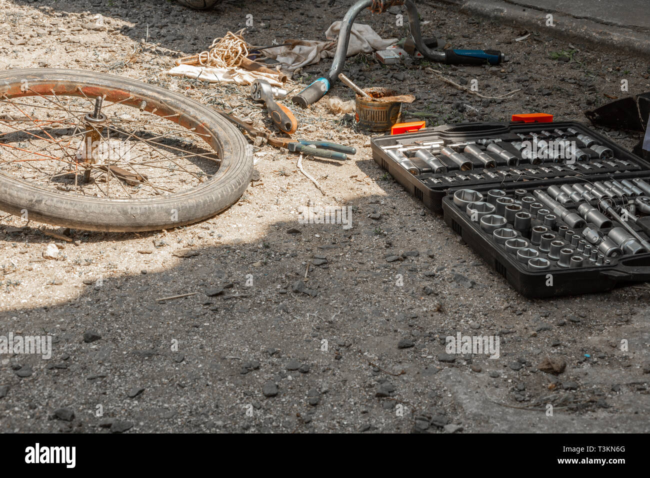 A set of socket keys in a box and a bicycle wheel. Concept of bike ...