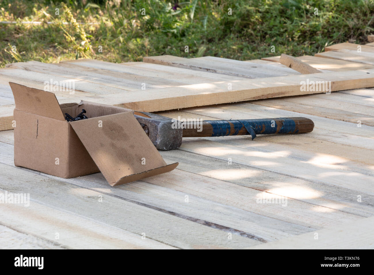 Screws, hammer, board. Tools carpenter Stock Photo - Alamy