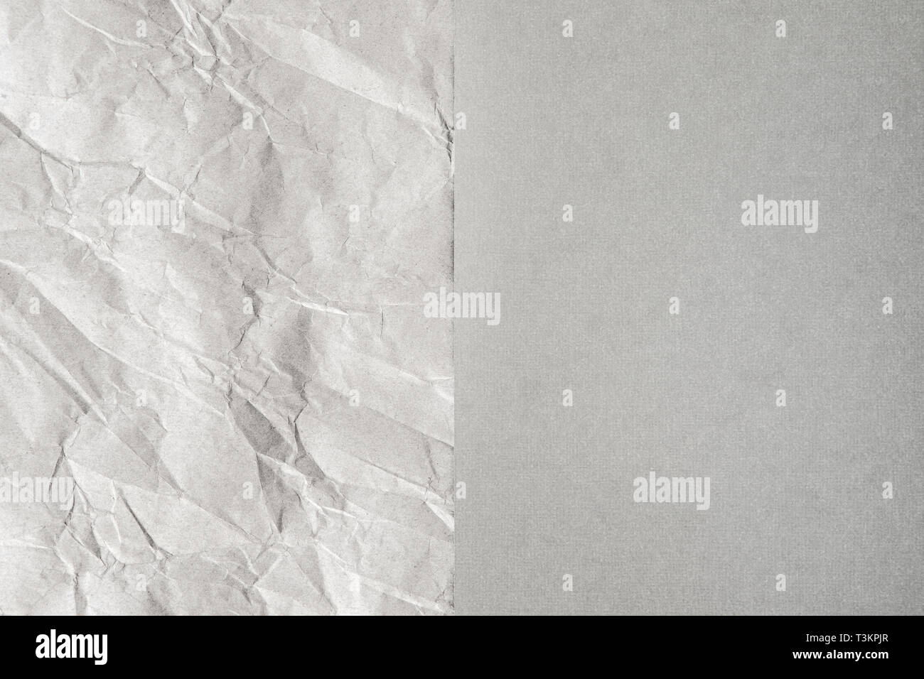 Crumpled and plain paper sheets divided in center creating line ...