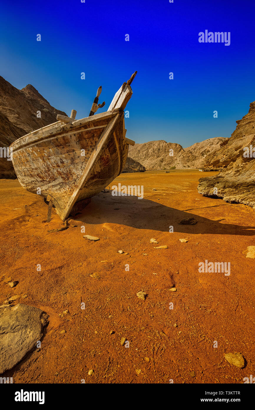 Abandoned aground boat near Yiti on low tide, Muscat, Sultanate of Oman ...