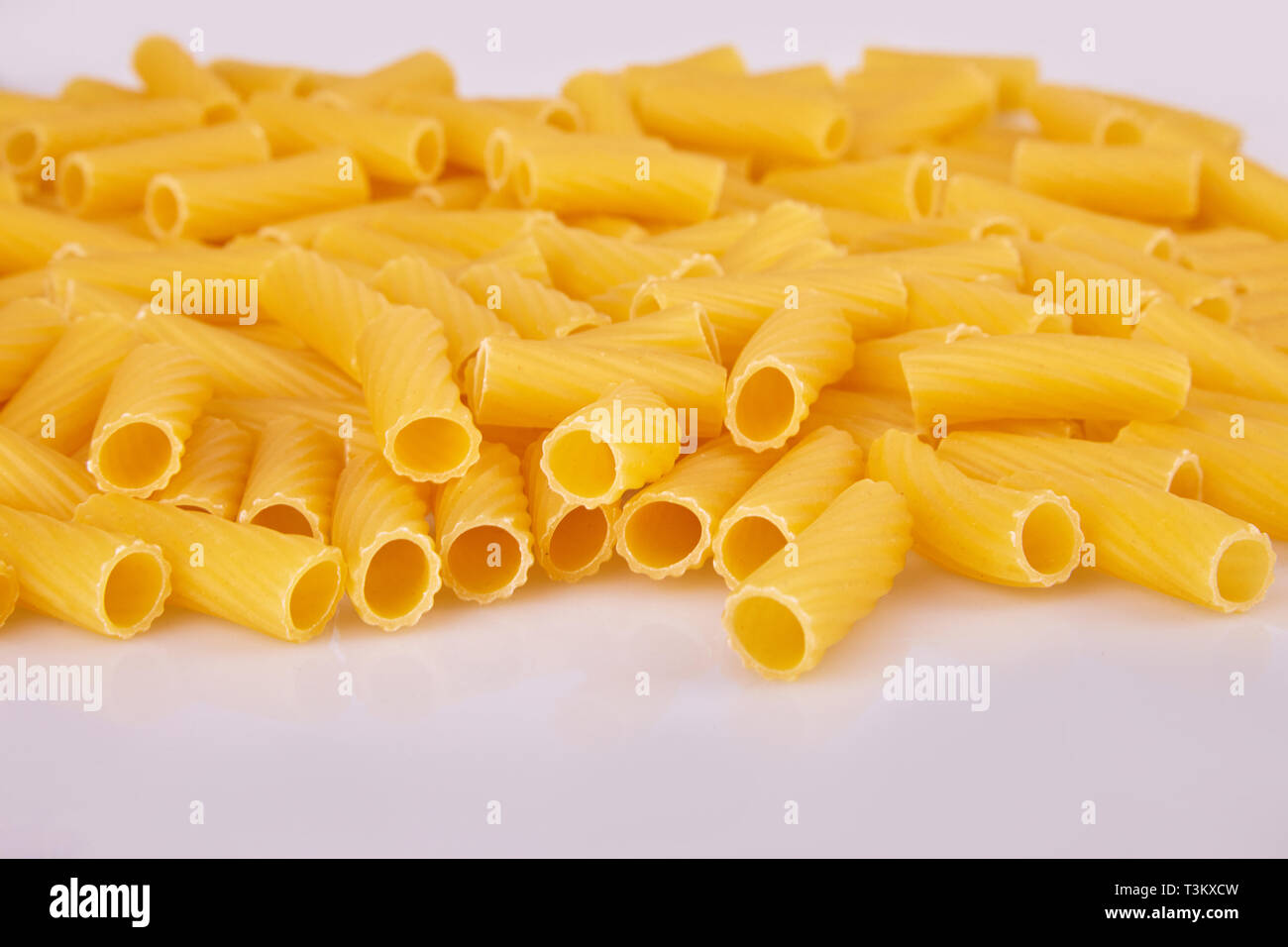 Raw pasta background. Uncooked pasta tubules background. Food ...